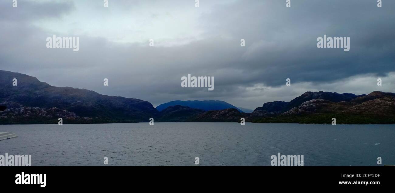mountain cloudy sky and clam ocean Stock Photo - Alamy