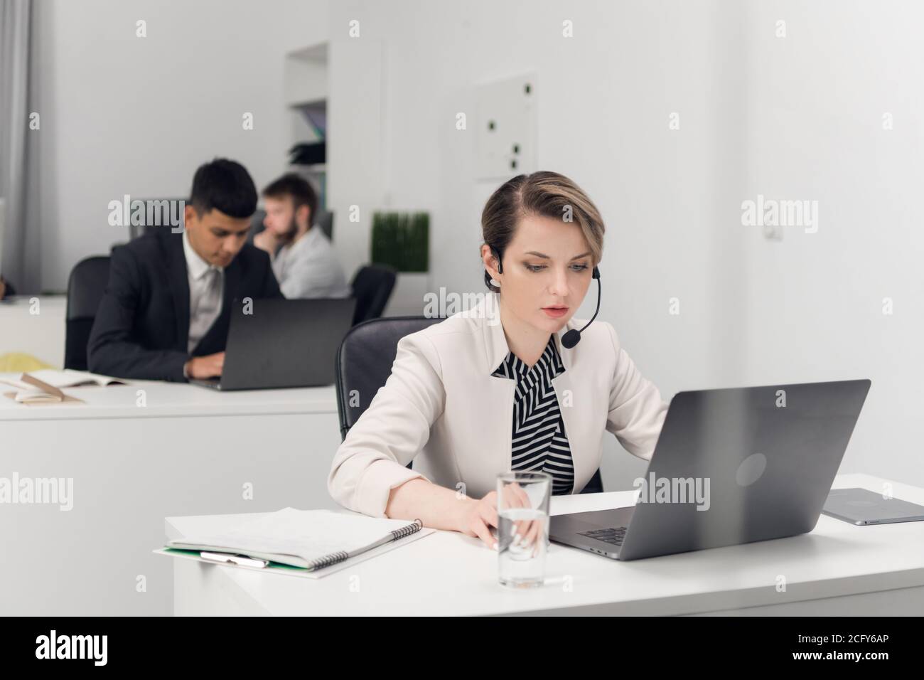 A call center employee sits at a Desk in the office of a large ...