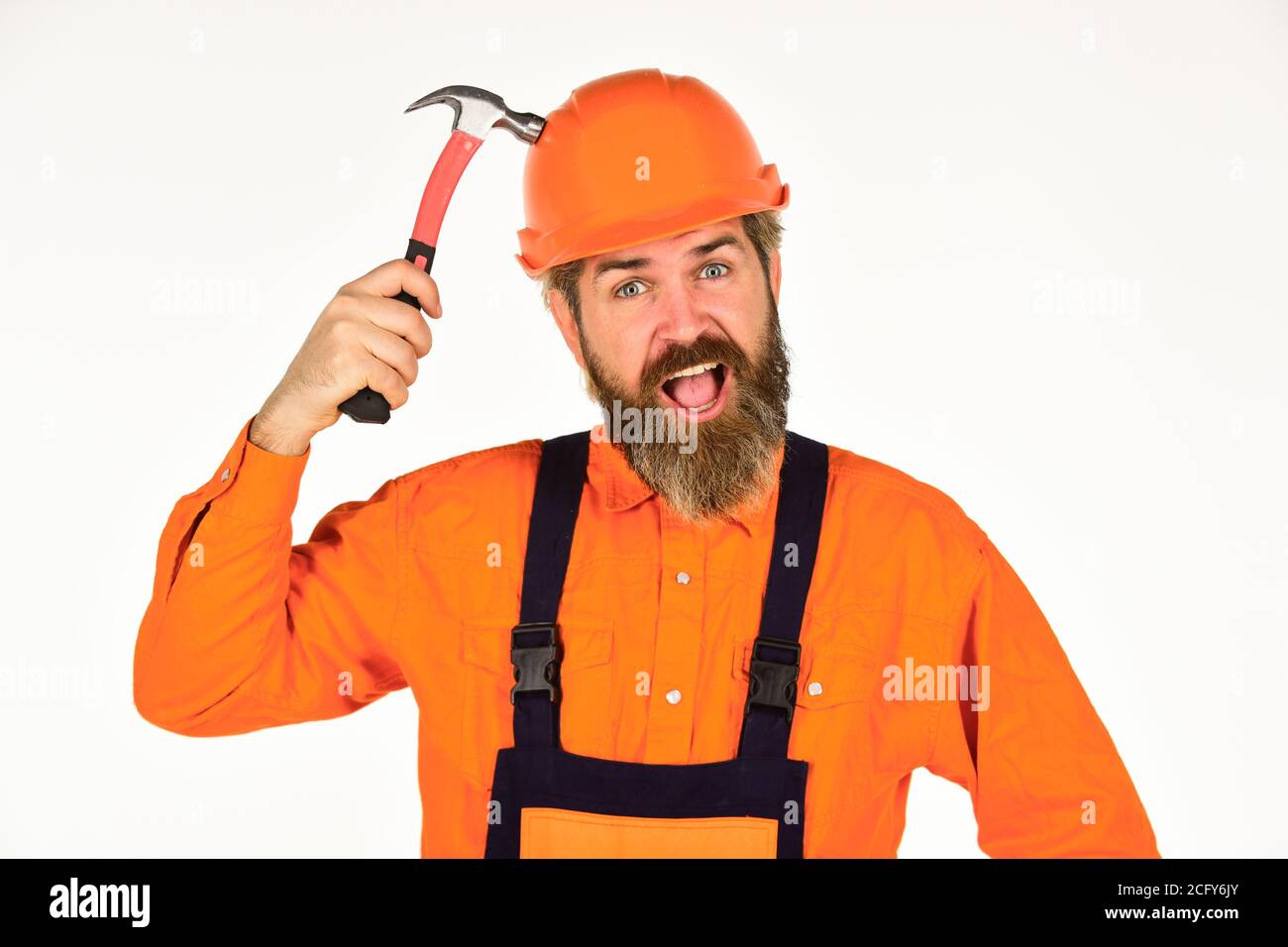 Impulse for changes. Bearded mature man in uniform. Guy with hammer ...
