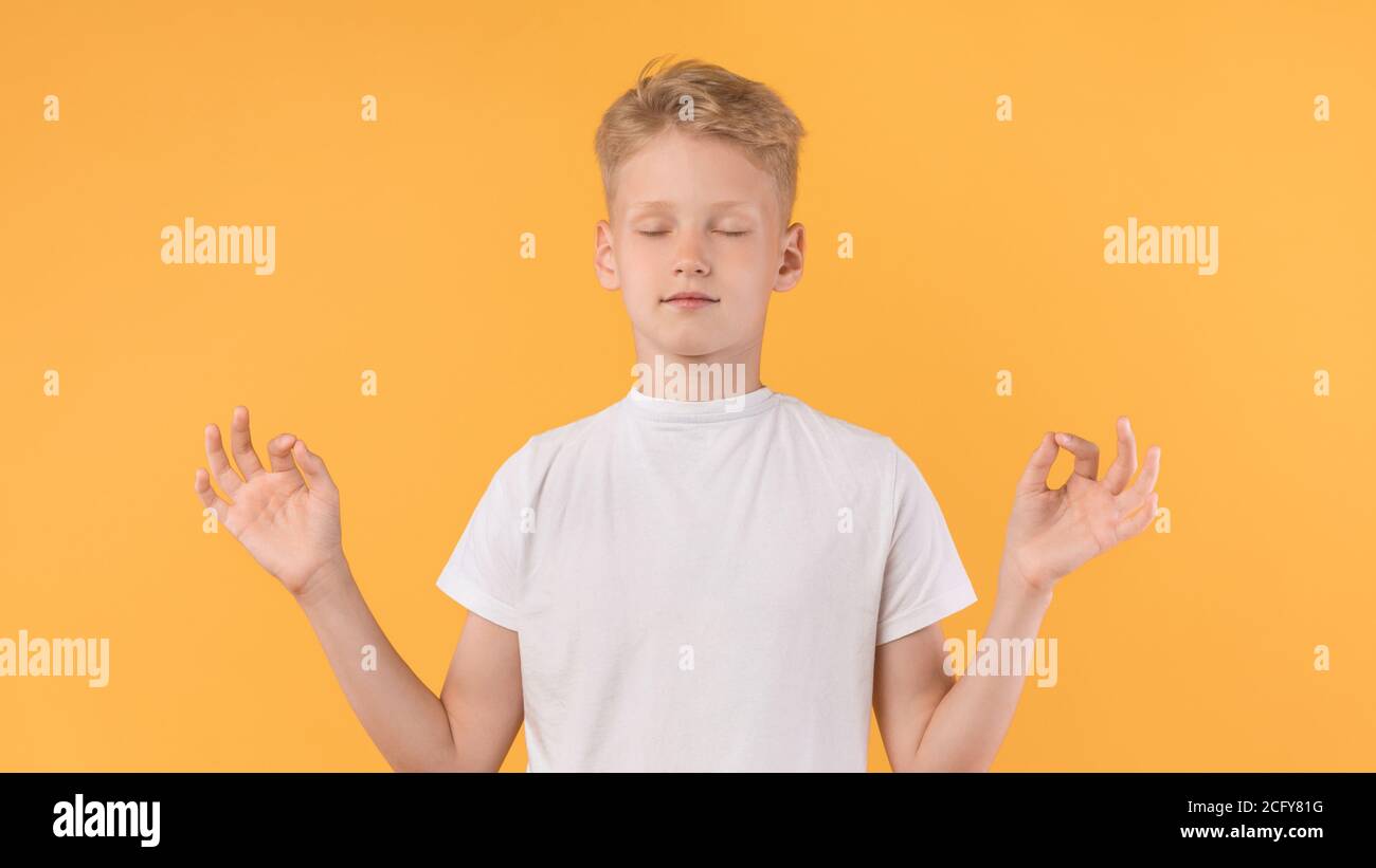 Portrait of relaxed boy meditating with closed eyes Stock Photo - Alamy