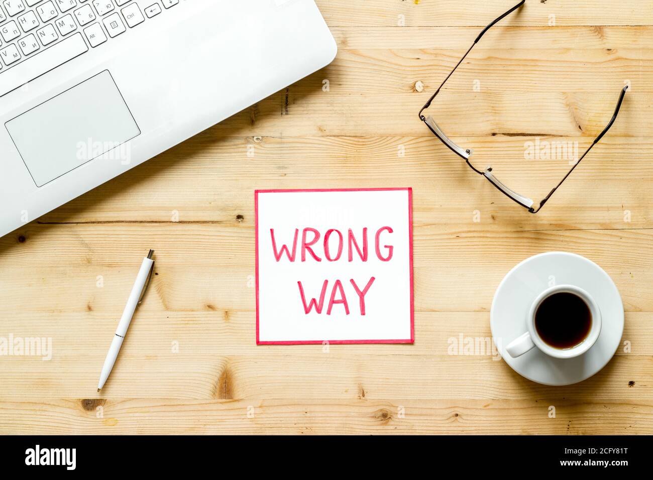 Business failure. Wrong way icon on wooden desk top-down Stock Photo ...