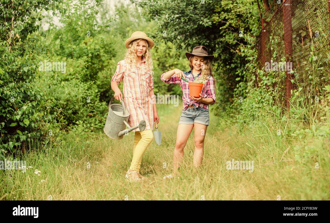 Kids having fun at farm. Eco farming concept. Planting and watering ...