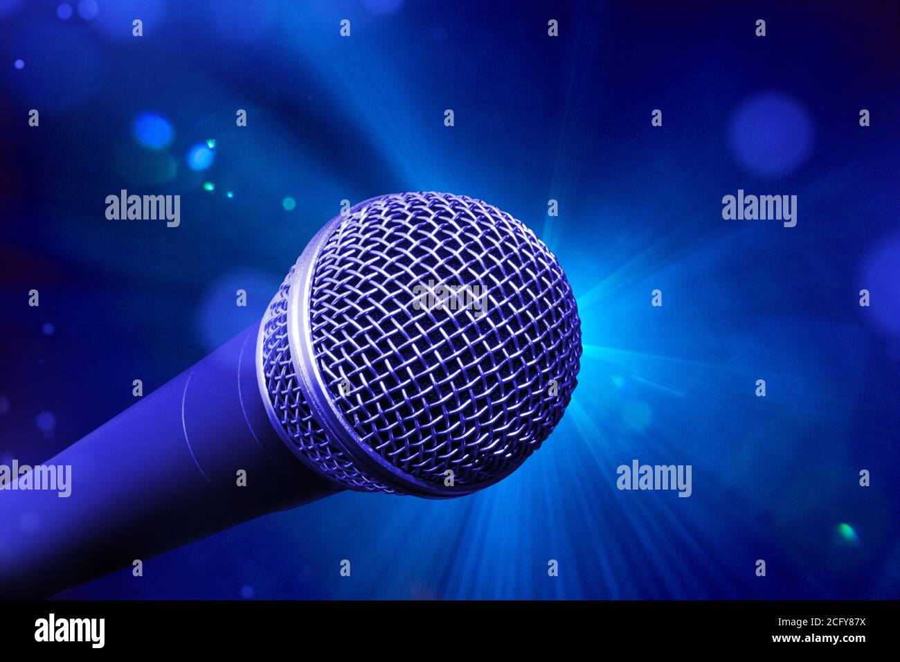 Microphone close-up on stage blurred background Stock Photo - Alamy