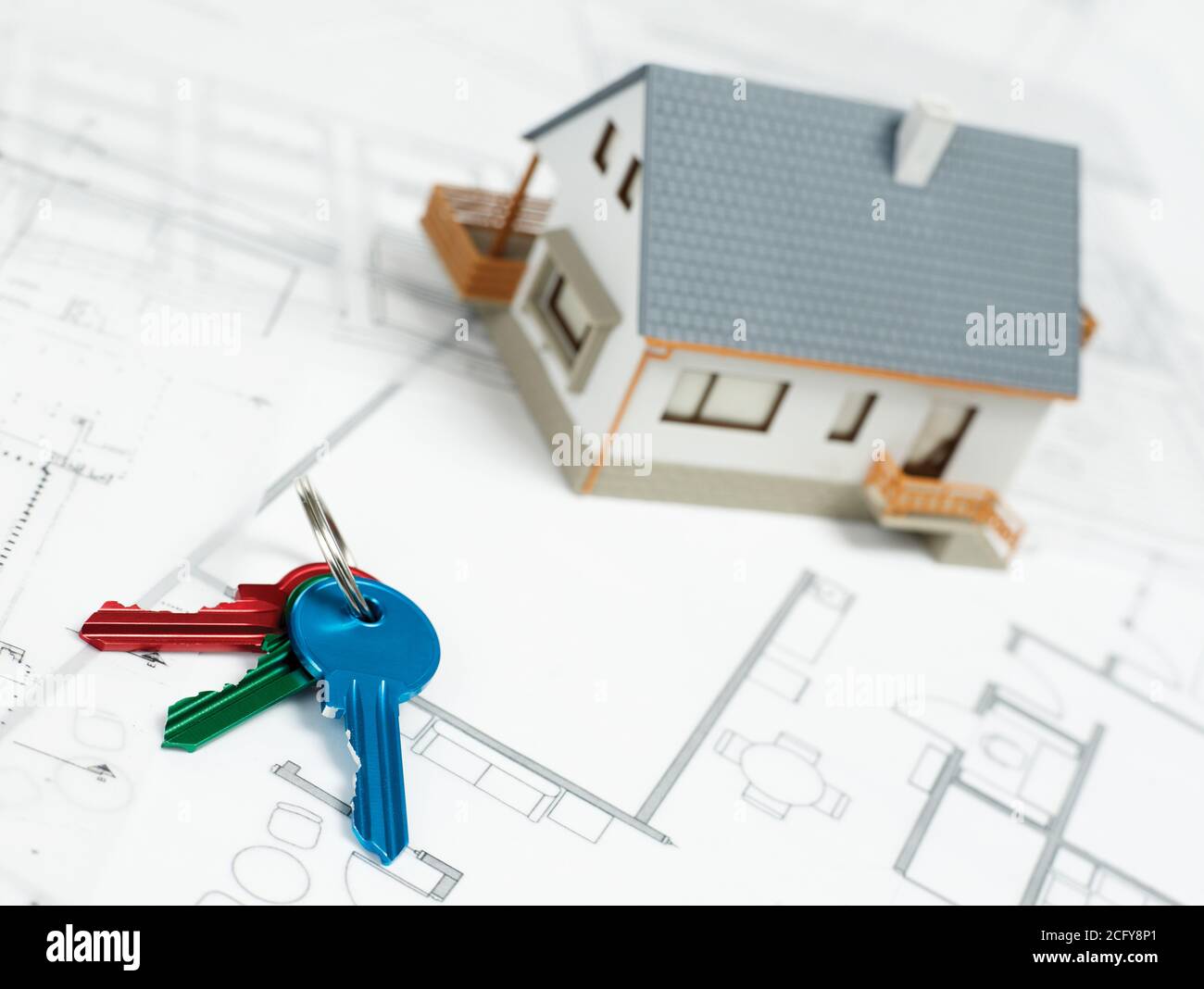 Keys and model house on blueprints Stock Photo - Alamy