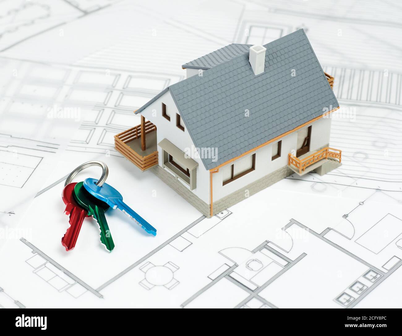 Keys and model house on blueprints Stock Photo - Alamy