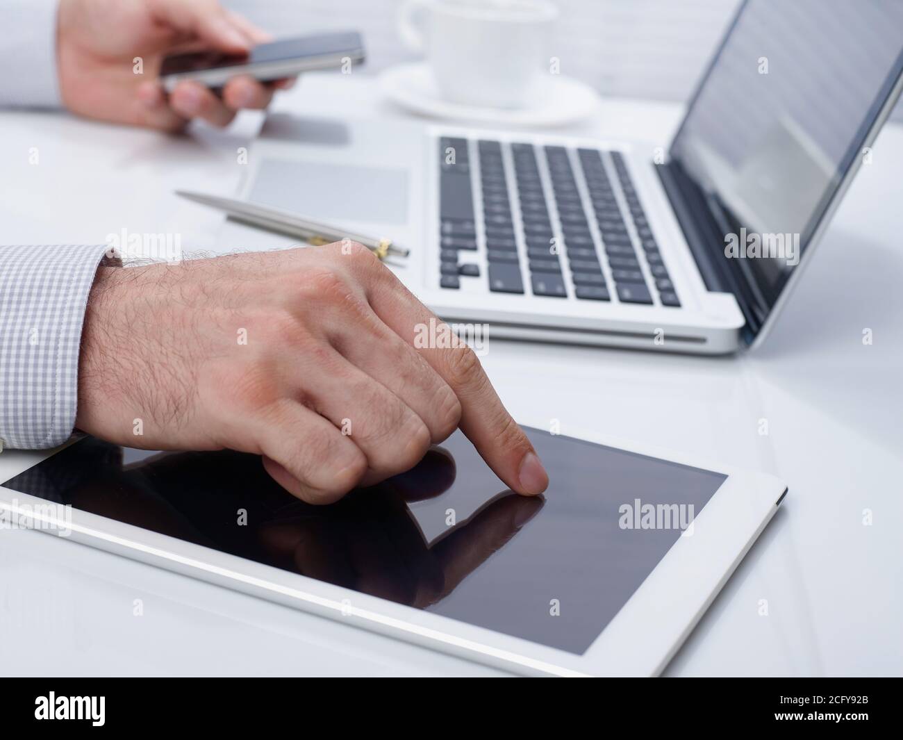 Business man with multiple devices Stock Photo - Alamy