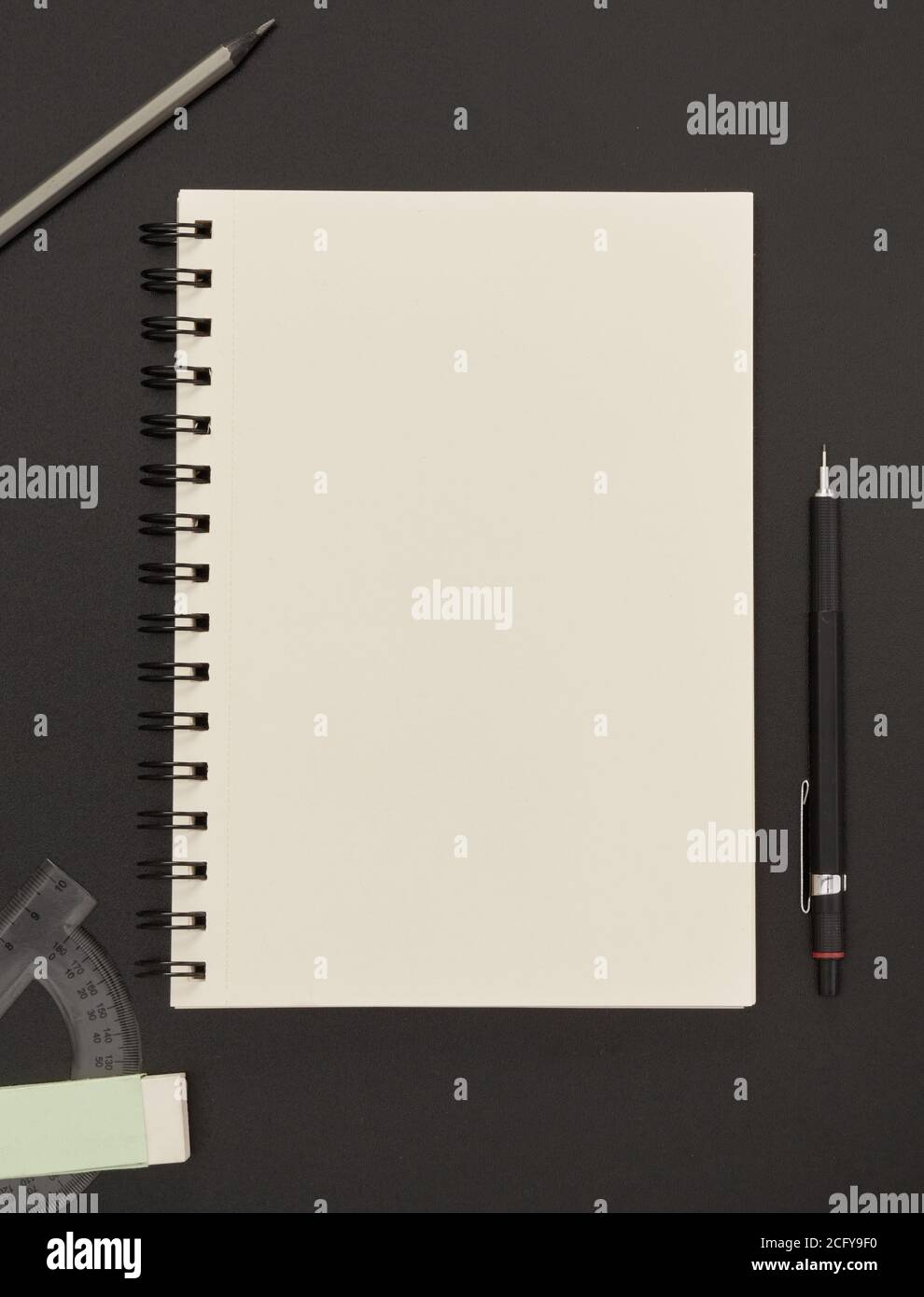 Notebook, pencil and eraser on blackboard Stock Photo - Alamy