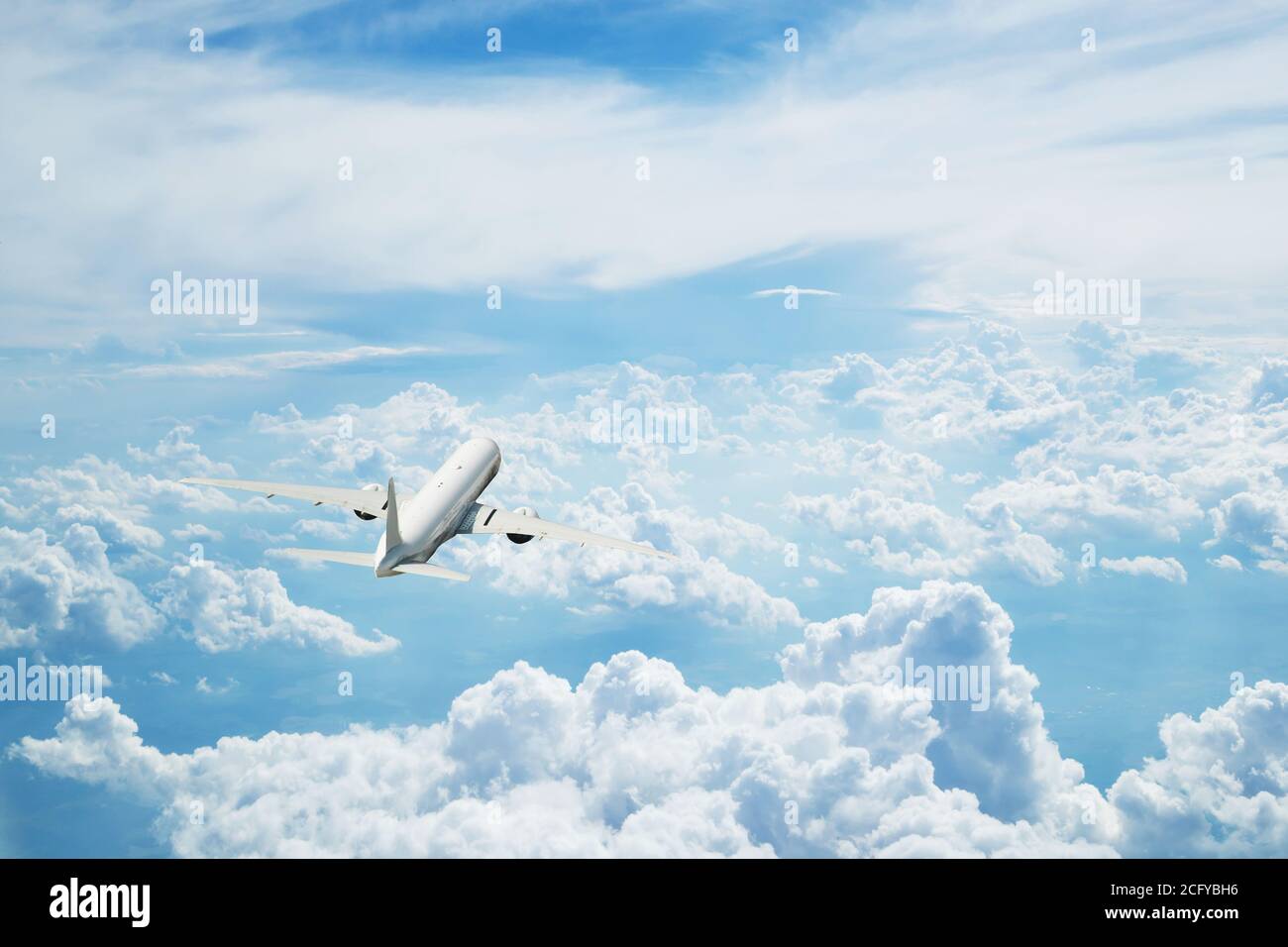 Back view of commercial airplane flying above clouds. Copyspace for ...