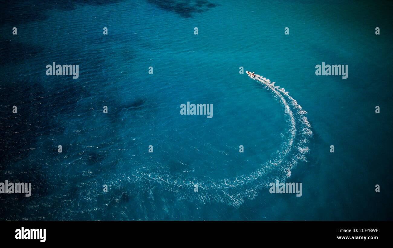 Aerial view of speed boat in motion. Water transportation and summer ...