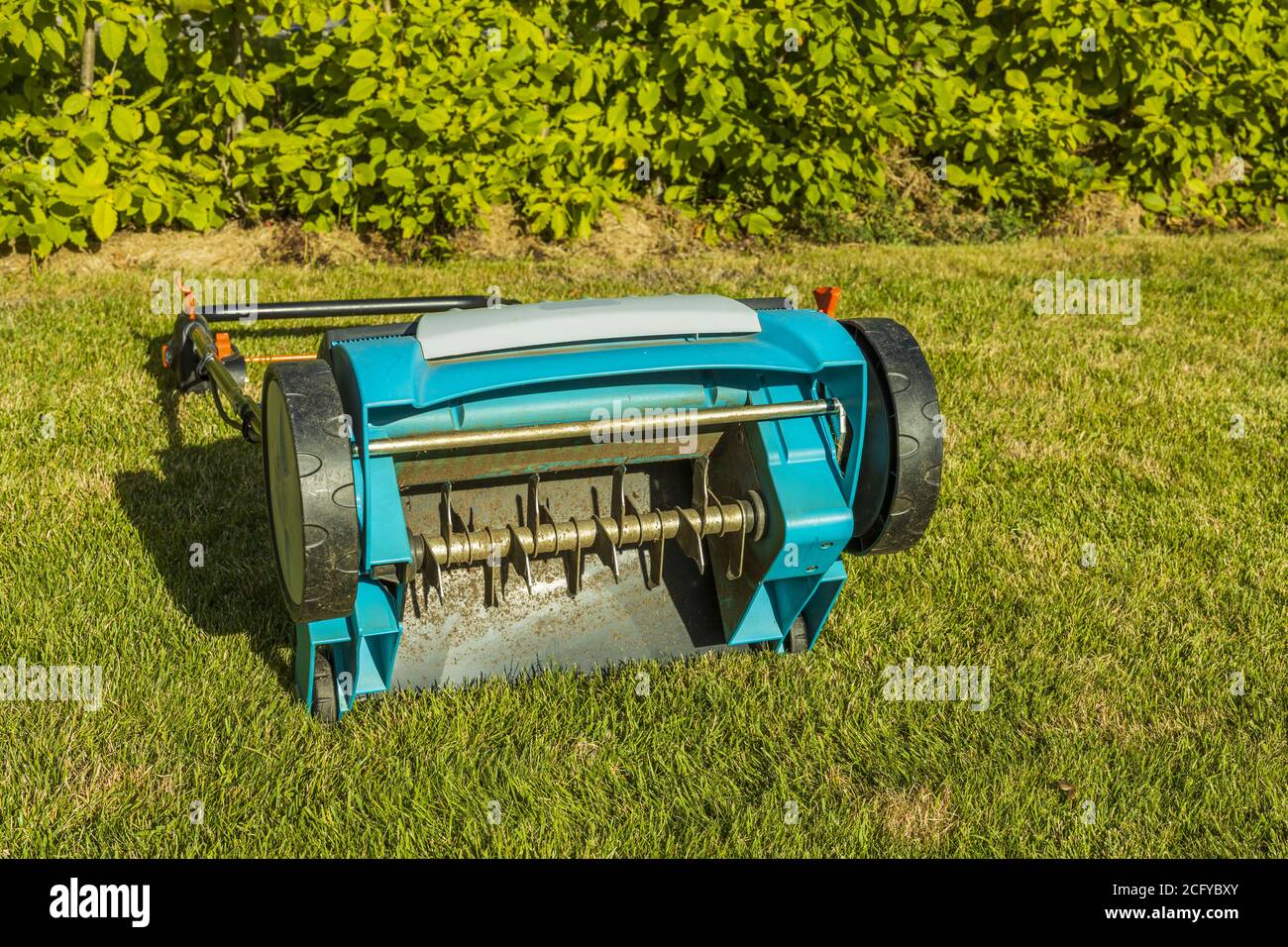 View of electric lawn aerator on green grass isolated. Garden machines ...
