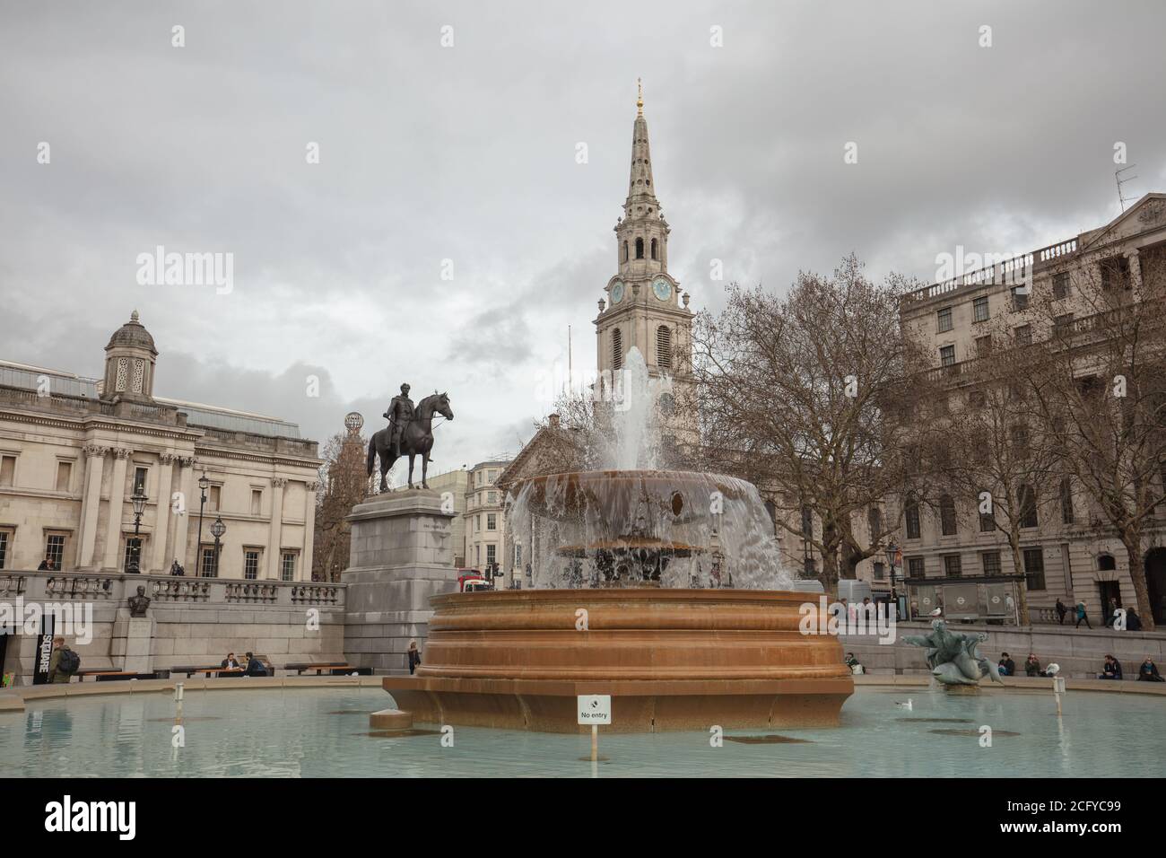 Close up of large fountain on Trafalgar Square with statue of George IV ...