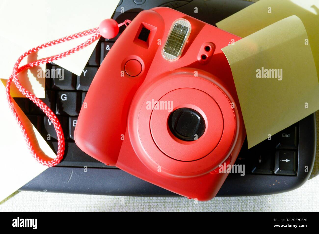 Top view of the camera, computer keyboard, and sticky notes on a flat ...