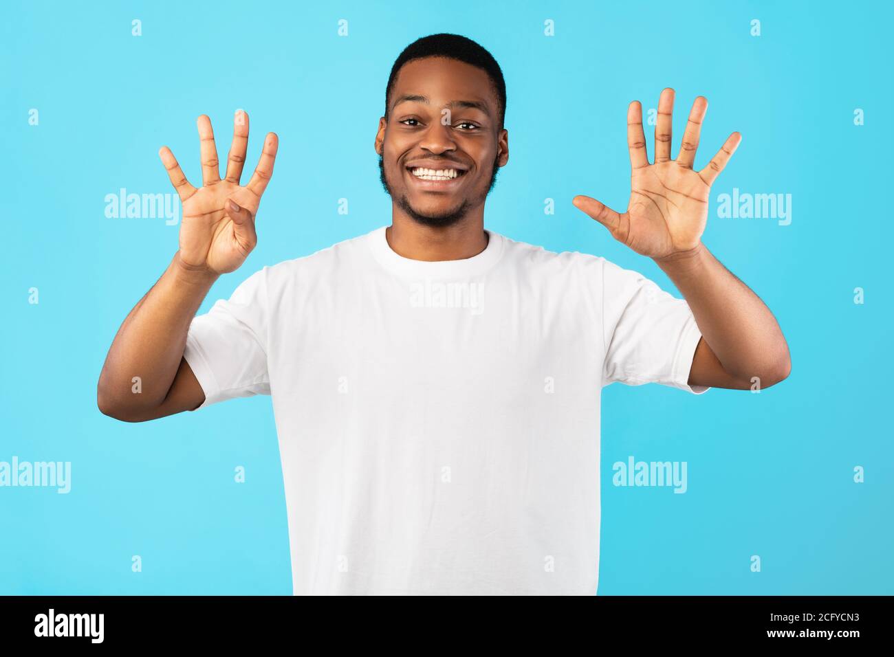 African Man Counting Showing Number Nine Standing In Studio Stock Photo ...