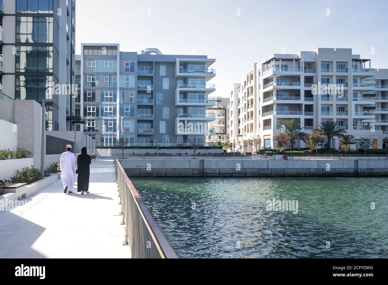Couple with facemask walking at the marina, Al Mouj, The Wave, Muscat, Oman Stock Photo - Alamy