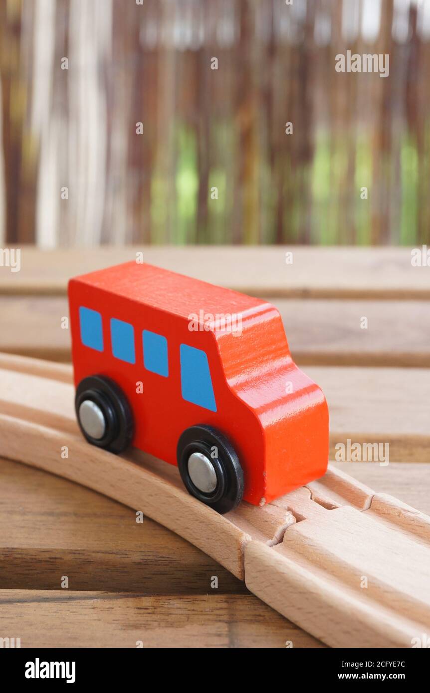 Red wooden toy bus on a track Stock Photo - Alamy