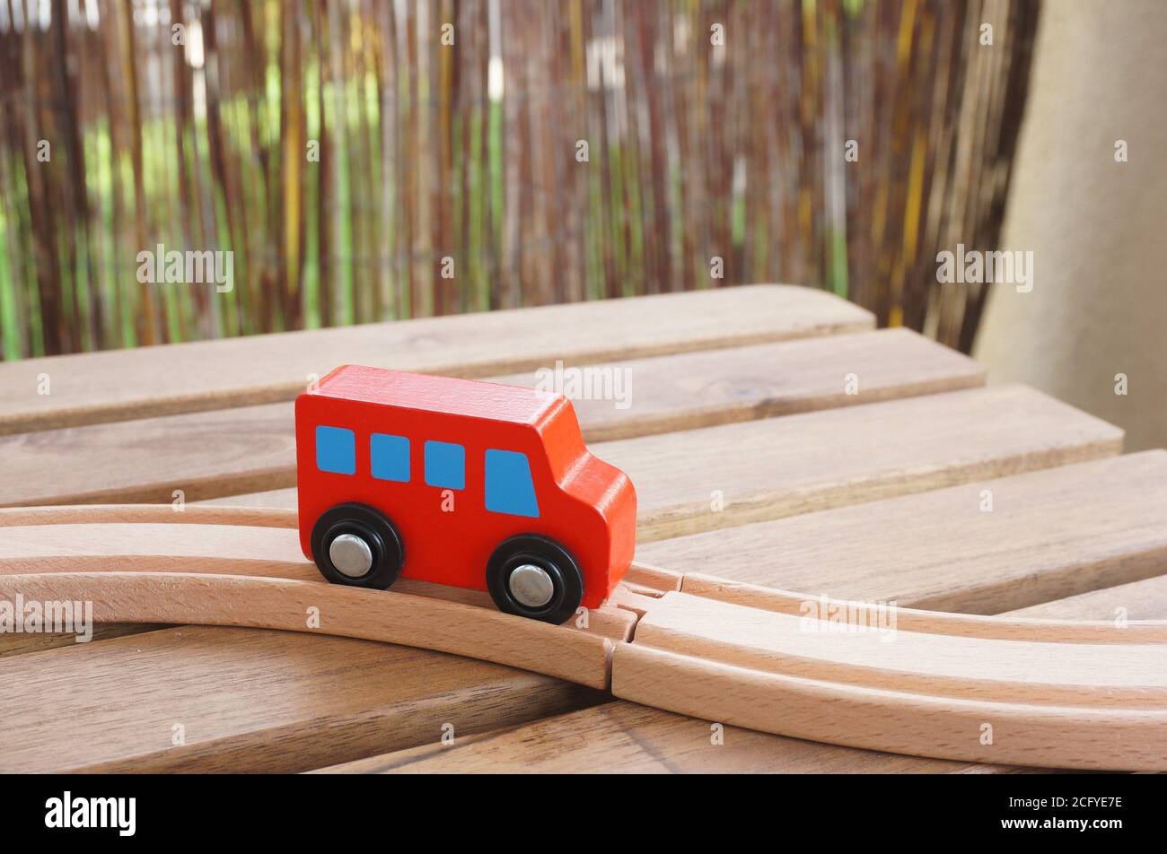 Red wooden toy bus on a track Stock Photo - Alamy
