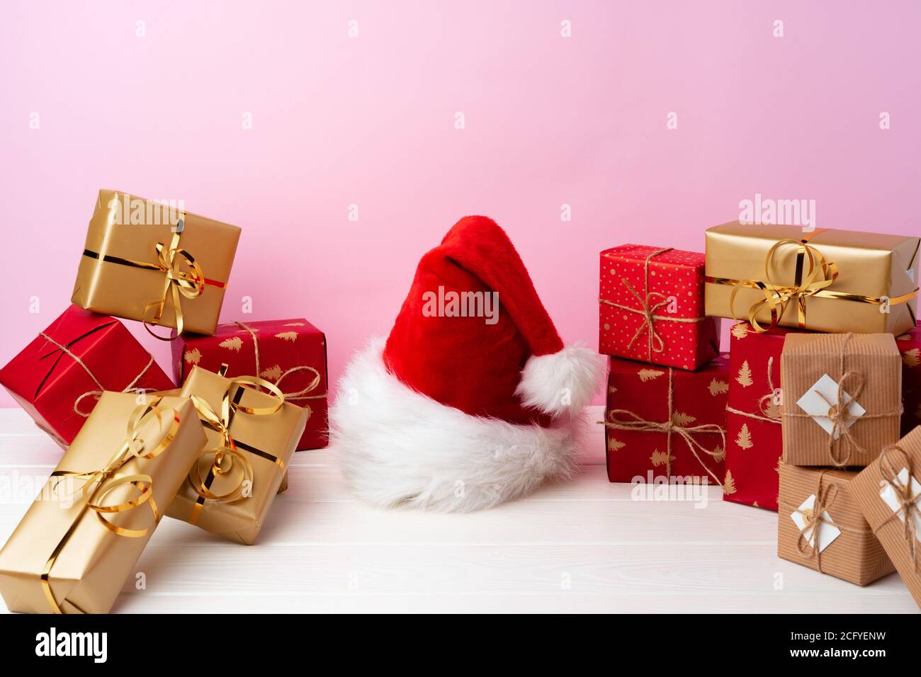 Pile of stacked gift boxes against pink background Stock Photo - Alamy