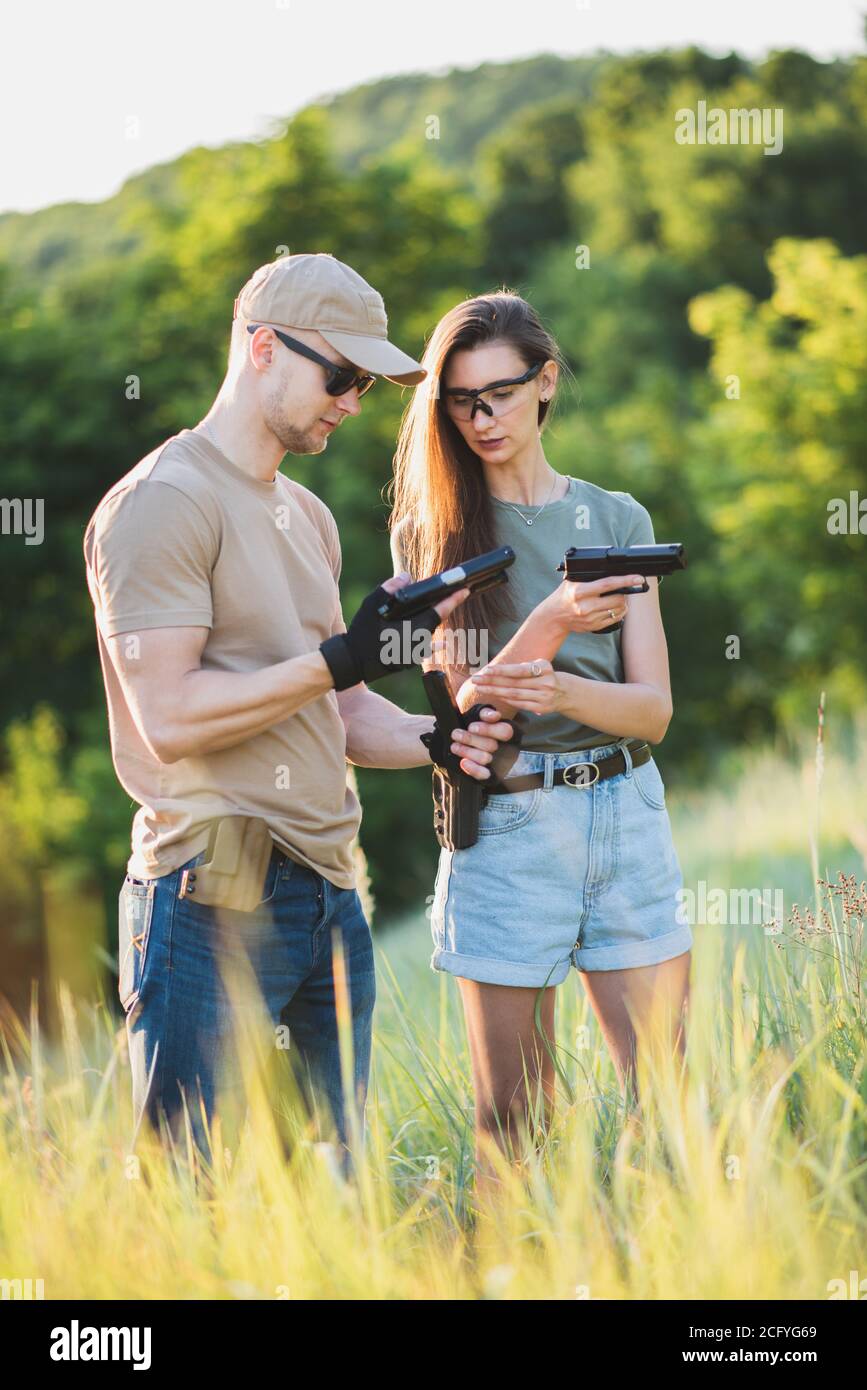 The shooting instructor teaches the backslider how to handle a weapon ...
