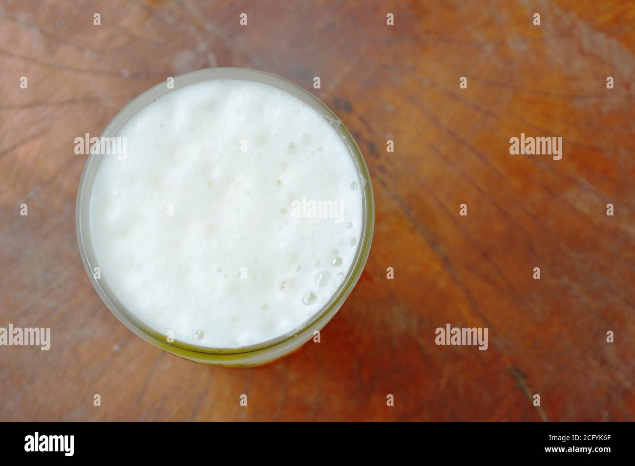cold beer with frothy in glass on wooden background Stock Photo - Alamy