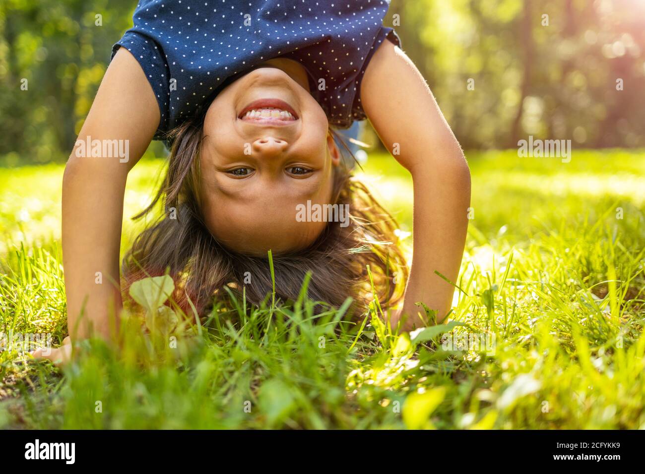 Child doing headstand hi-res stock photography and images - Alamy