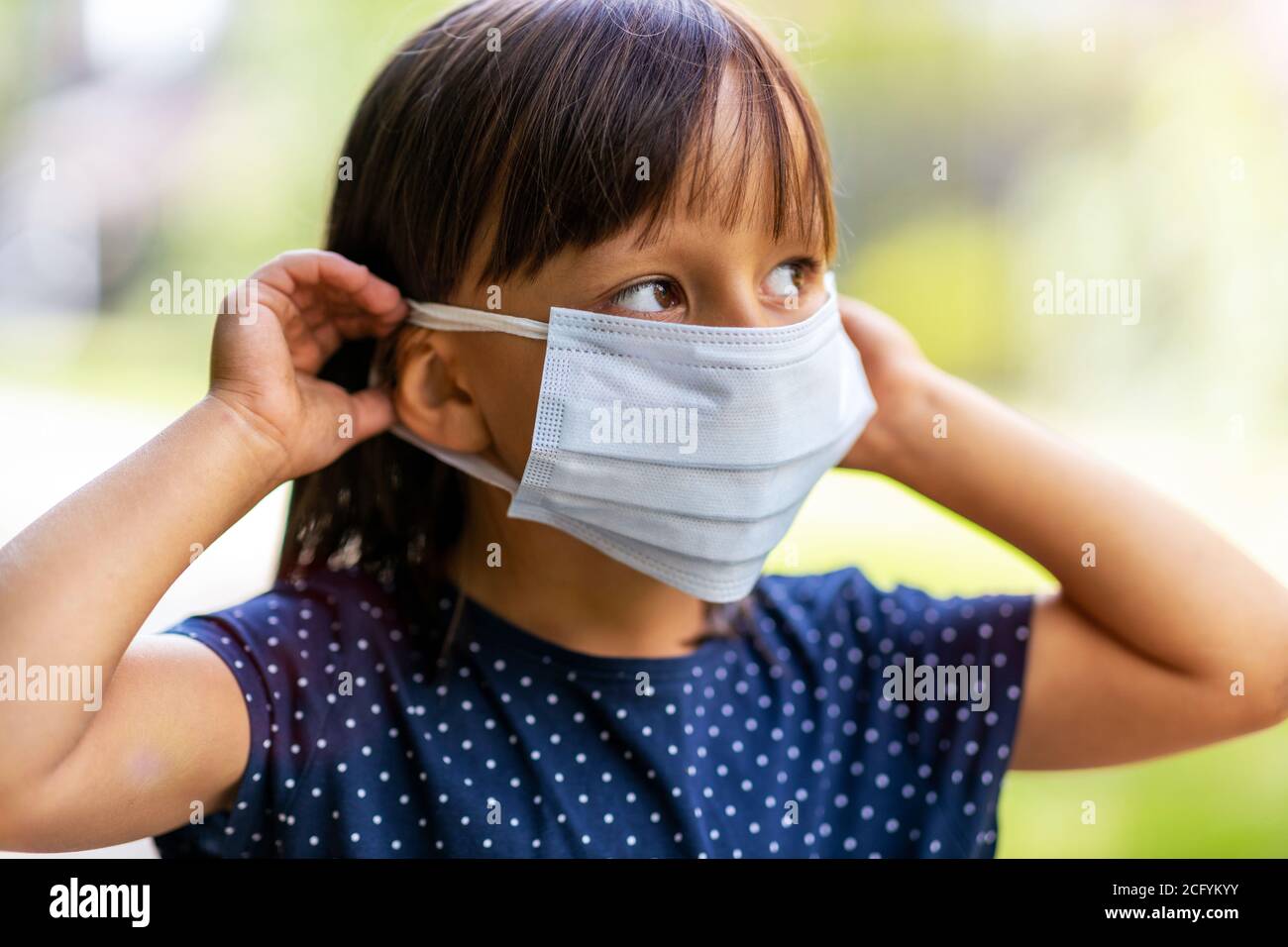 Little girl wearing protective mask Stock Photo - Alamy