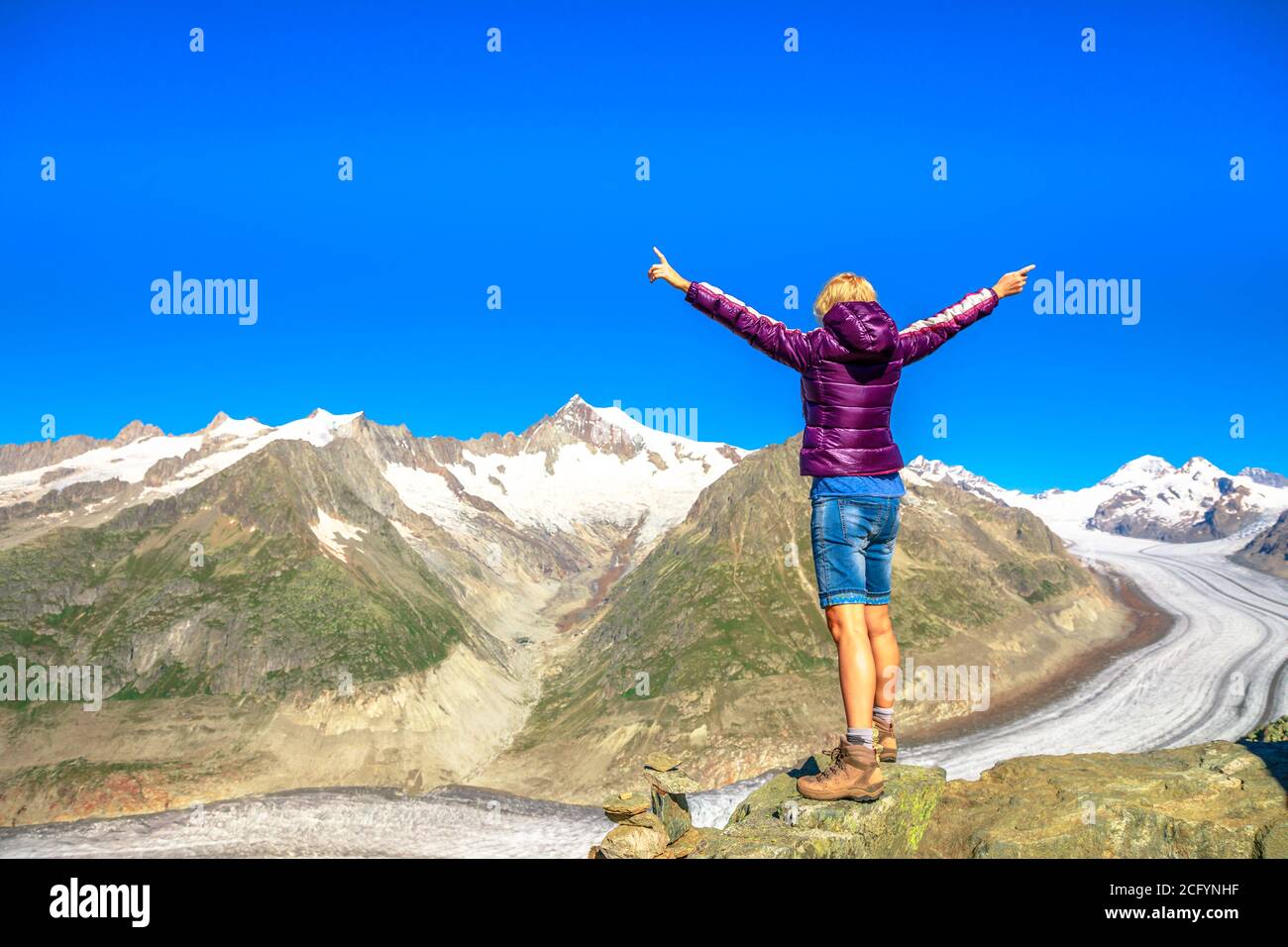 Hiking in Swiss Alps, Canton of Valais, Europe. Blonde carefree woman ...