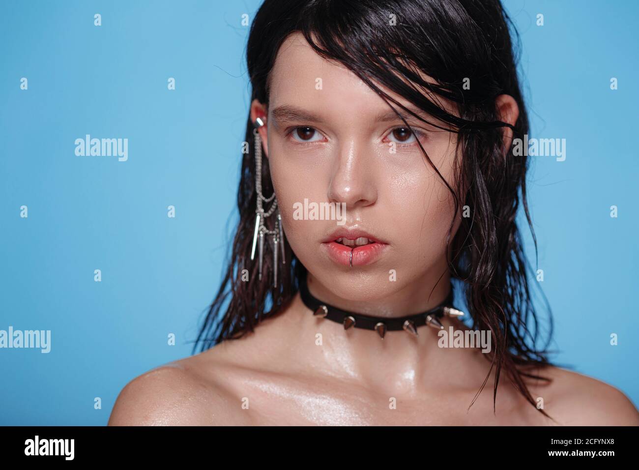 Portrait of beautiful Gothic woman with piercings and other accessories ...