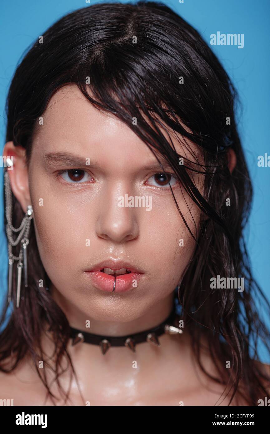 Portrait of beautiful Gothic woman with piercings and other accessories ...