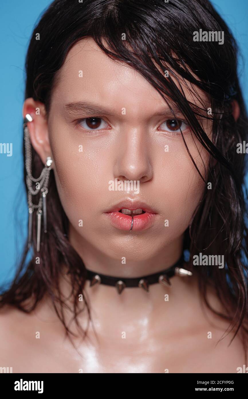 Portrait of beautiful Gothic woman with piercings and other accessories ...