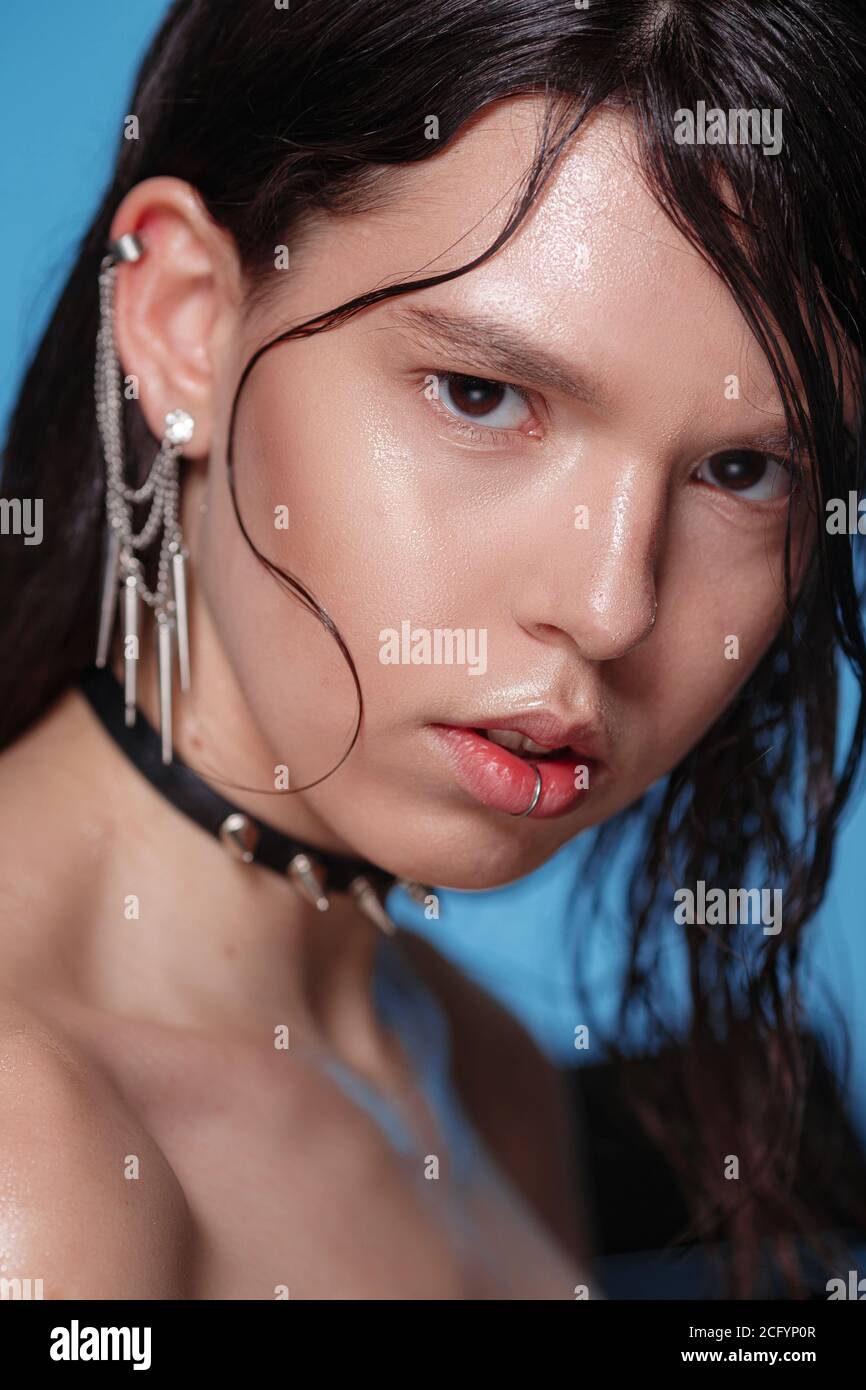 Portrait of beautiful Gothic woman with piercings and other accessories ...