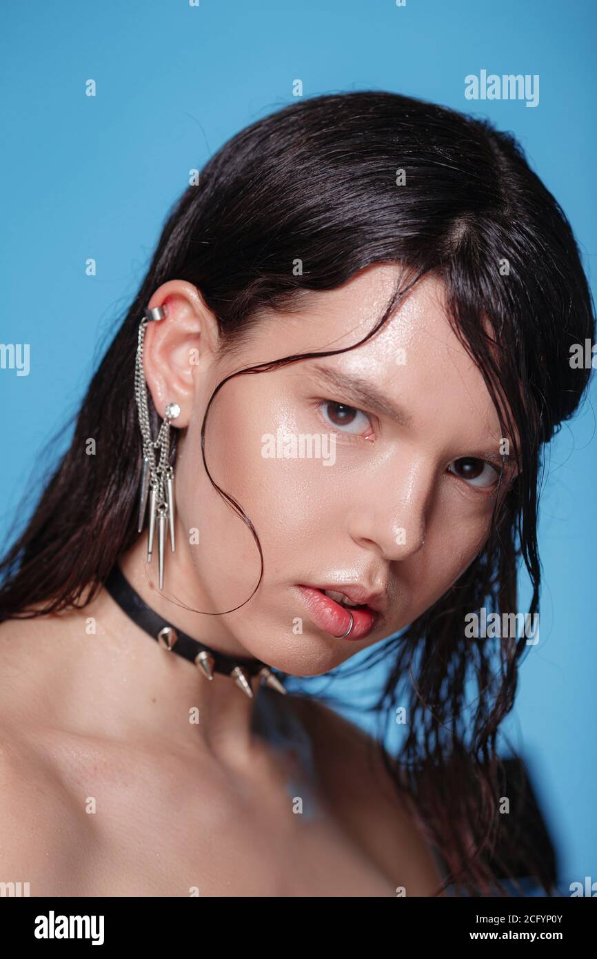Portrait of beautiful Gothic woman with piercings and other accessories ...