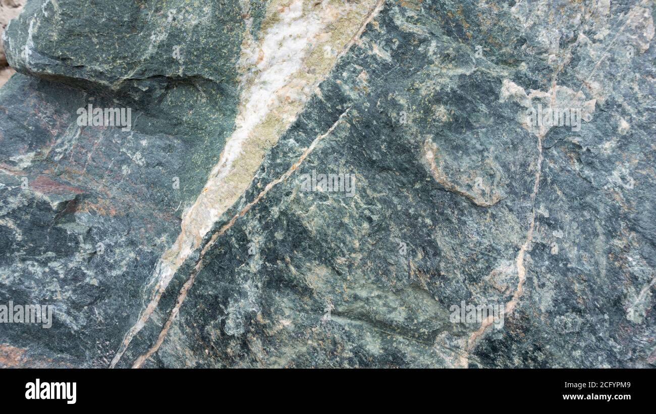 Stone background with embossed texture and colored inserts of white and ...