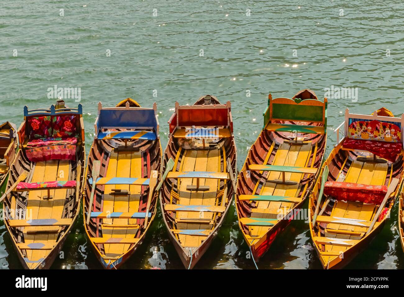 Boats floating on water in a lake in hill station Bhimtal in Nainital ...