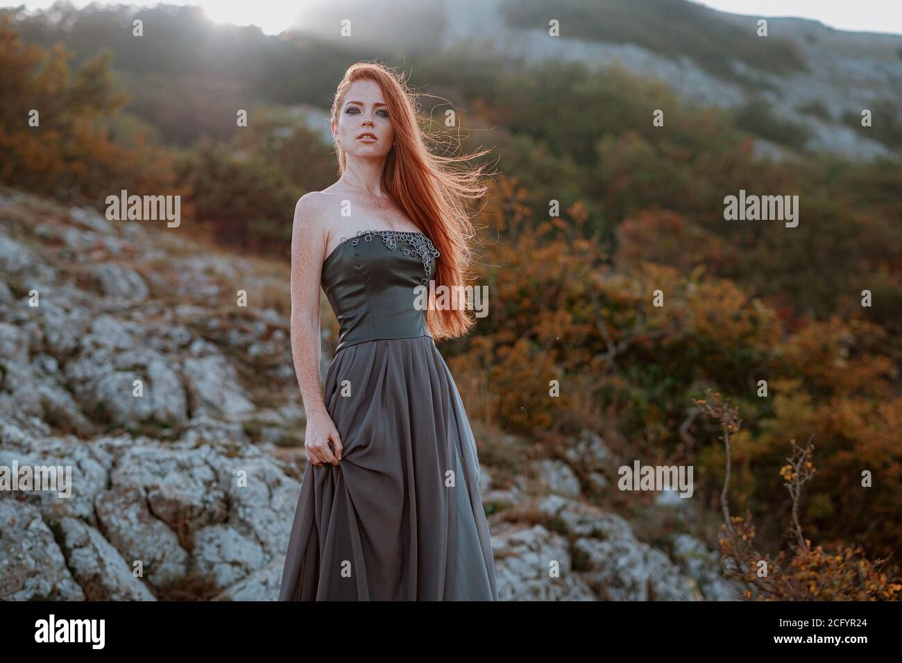 beautiful furious scandinavian warrior ginger woman in grey dress with ...