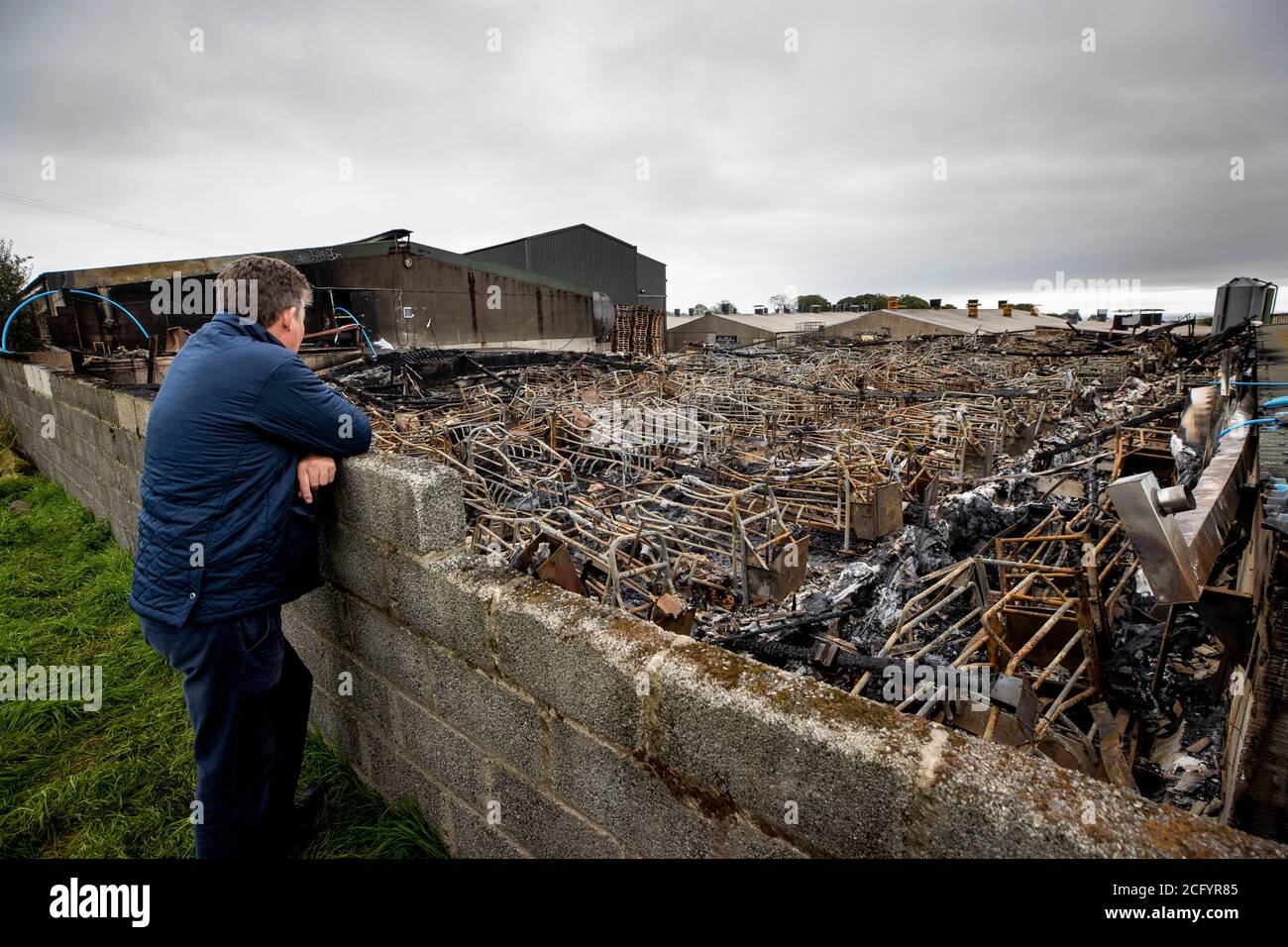 Trevor Shields looks over the remains of an overnight fire at his ...
