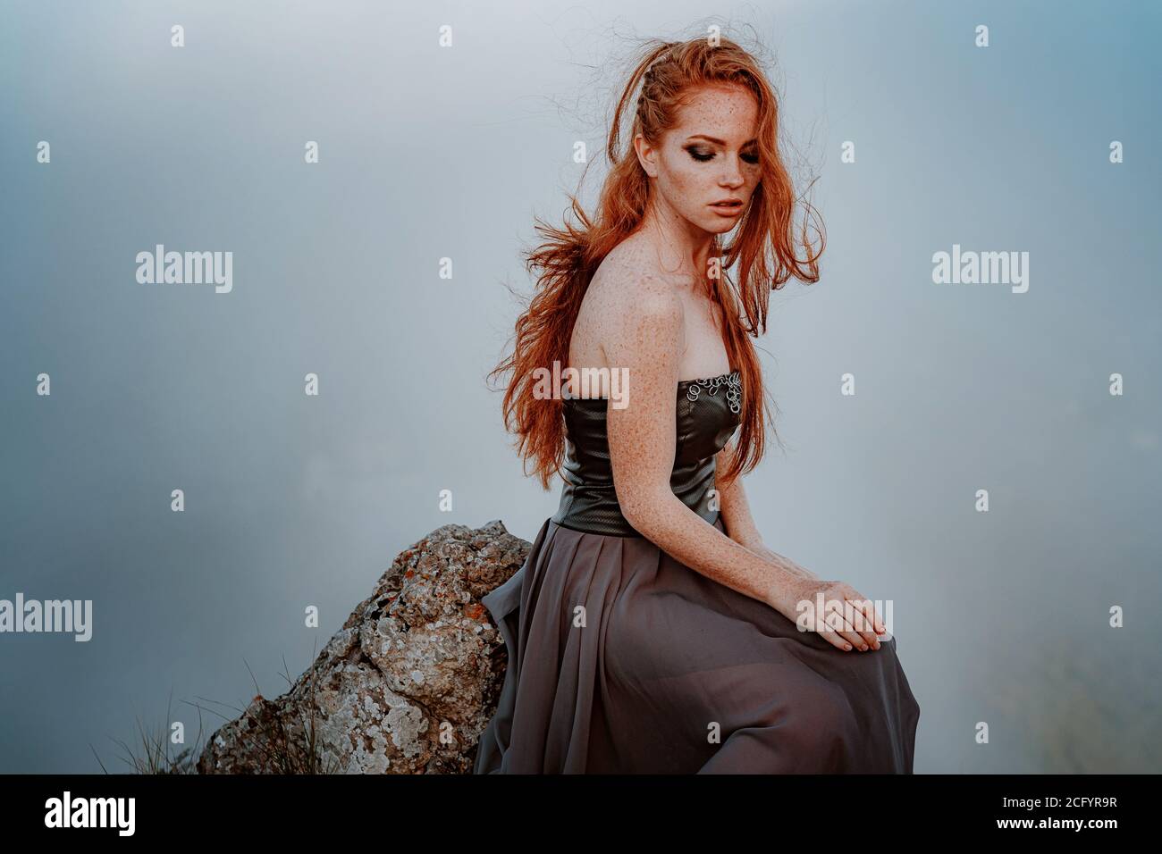 beautiful furious scandinavian warrior ginger woman in grey dress with ...