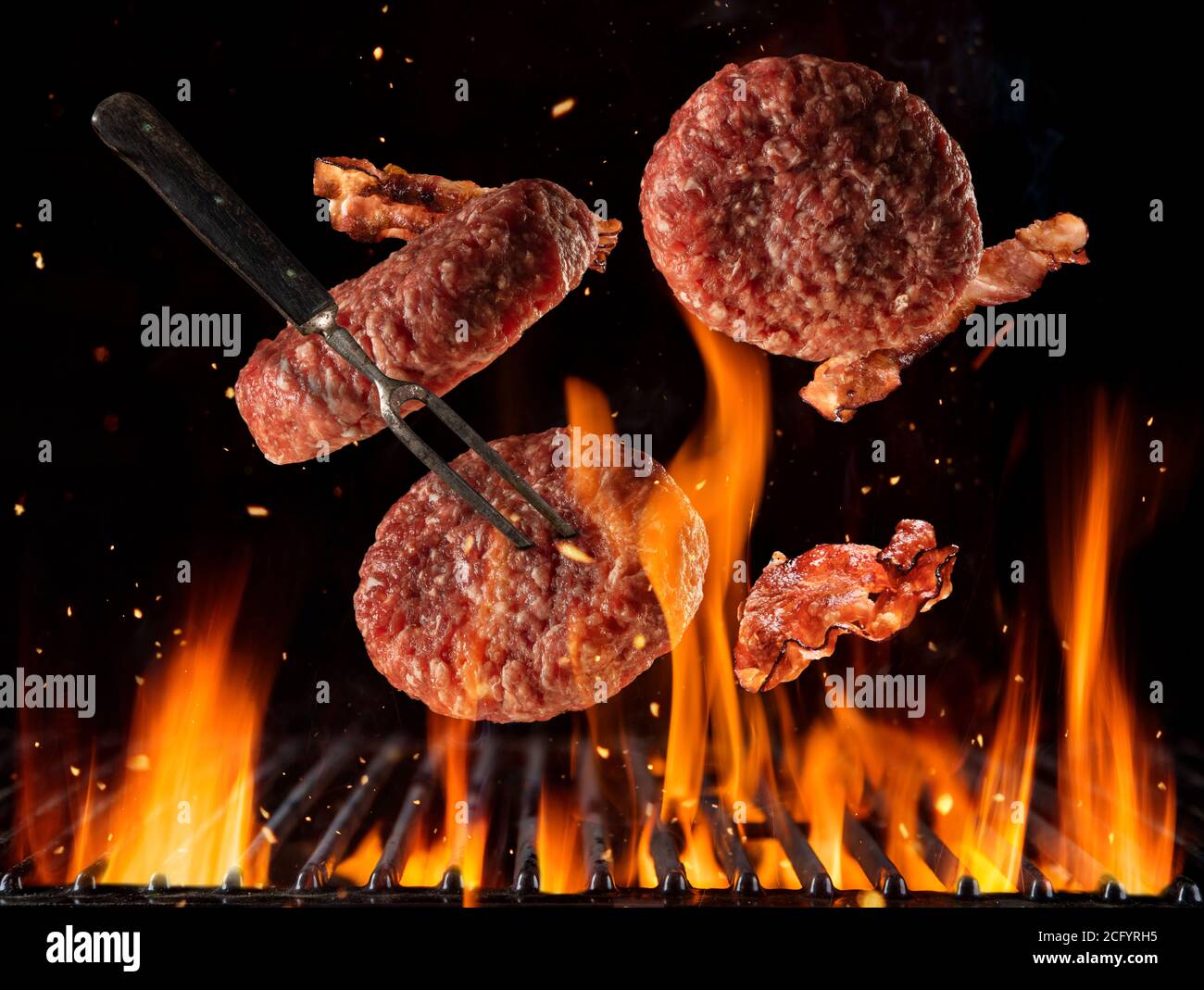 Flying beef raw hamburgers pieces above burning grill grid, isolated on ...