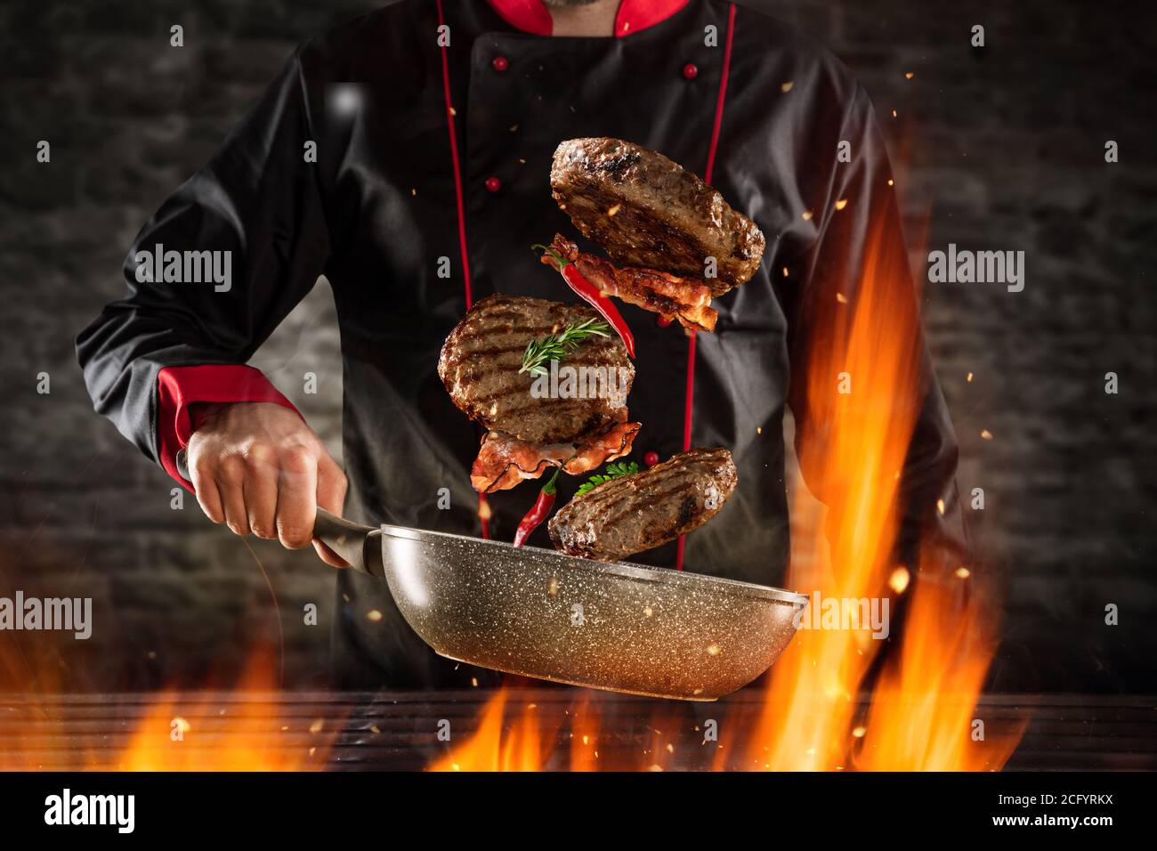 Closeup of chef throwing hamburger steaks into the air. Concept of food ...