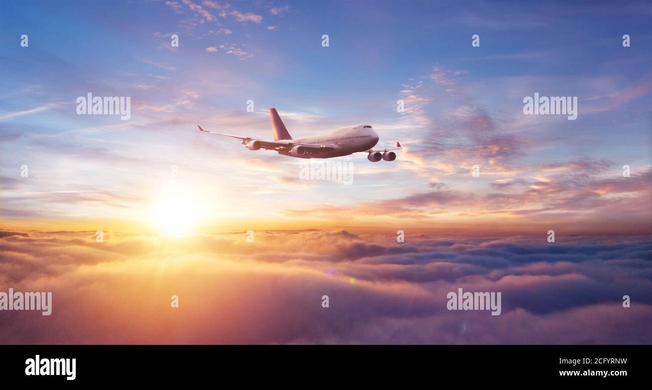 Huge commercial airplane flying over dramatic sunset sky. Jet plane is ...