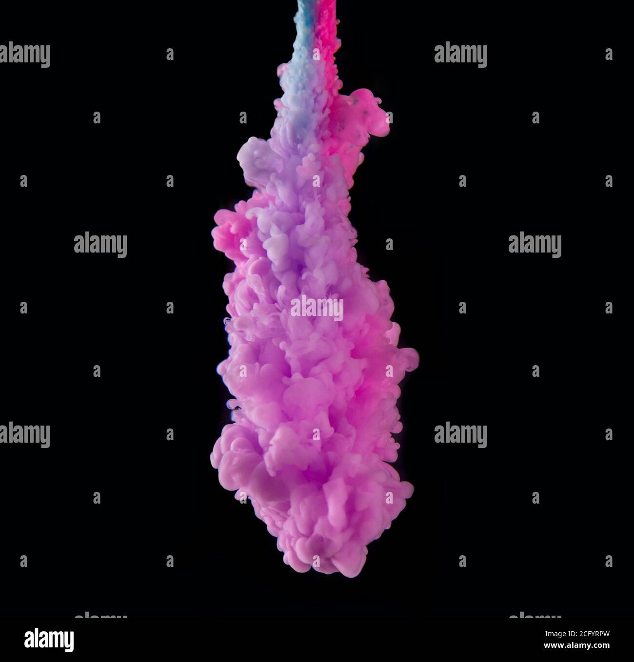 Coloured acrylic ink mixing in water isolated on black background ...