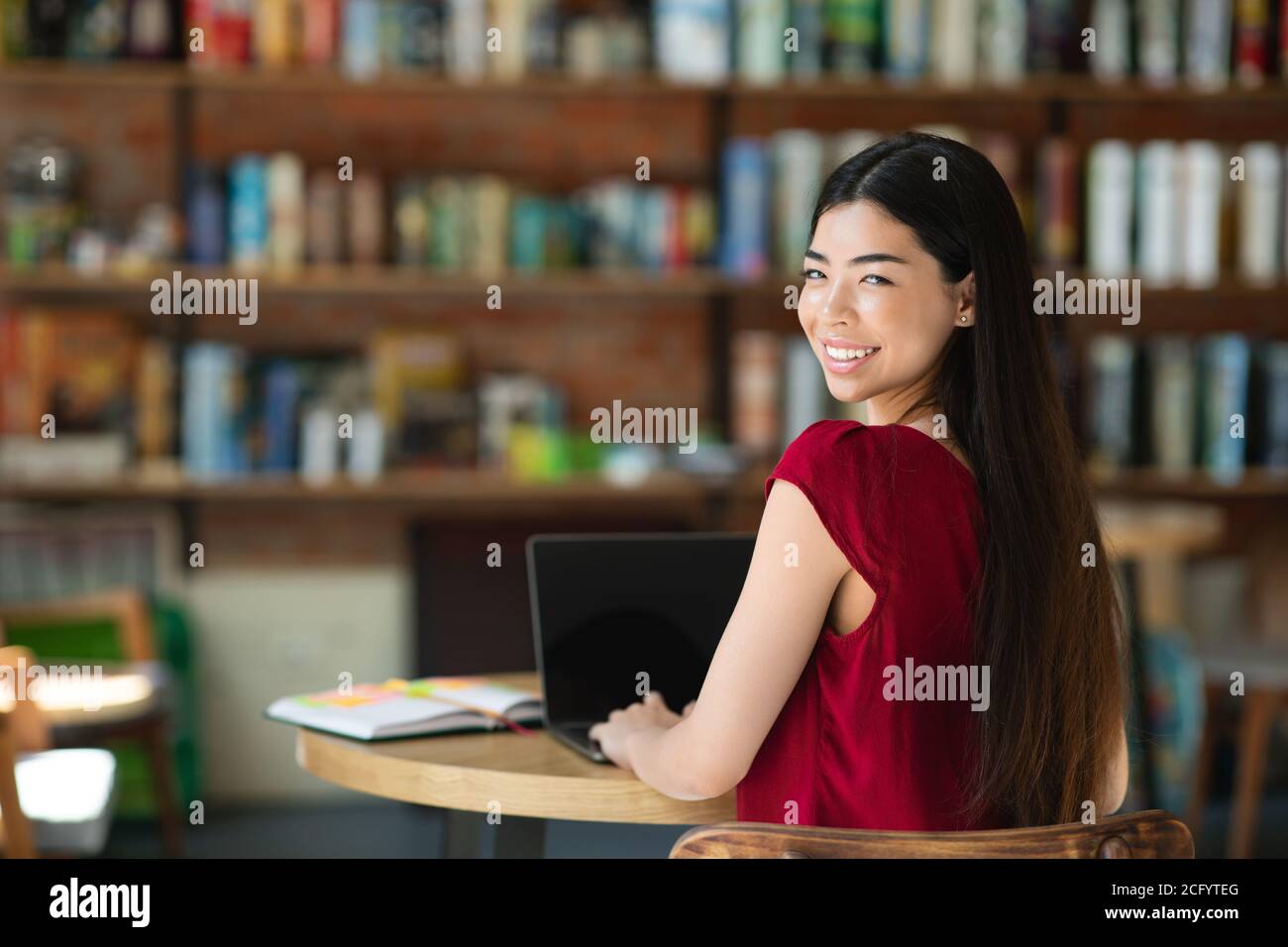 Employment In Remote. Asian Girl Using Laptop With Black Screen In Cafe ...