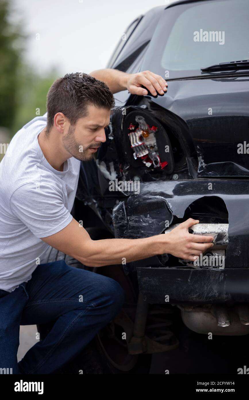 Unhappy Male Driver Inspecting Damaged Car After Accident Stock Photo ...