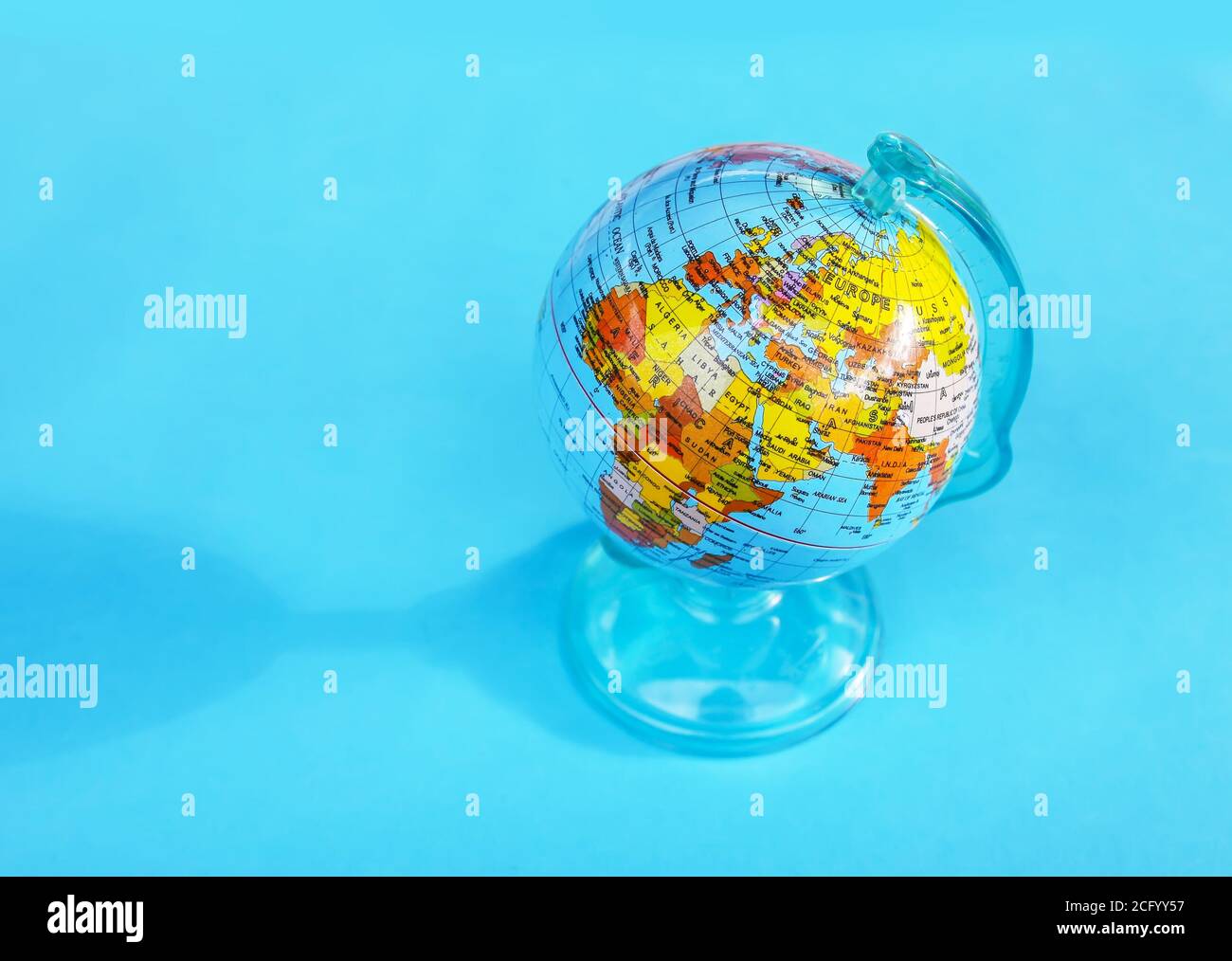 Small globe on blue background Stock Photo - Alamy