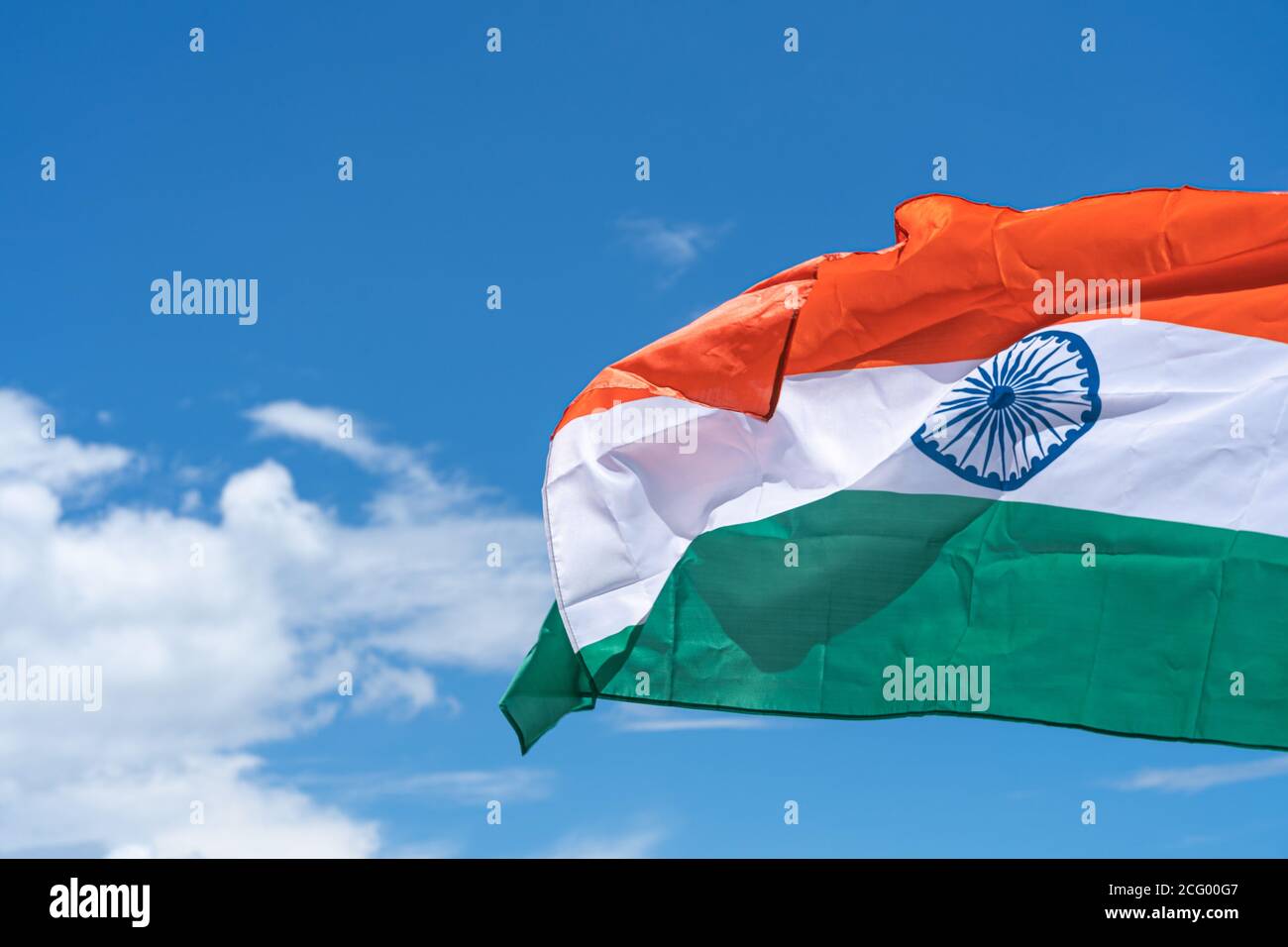 Waving India flag under blue sky background Stock Photo - Alamy