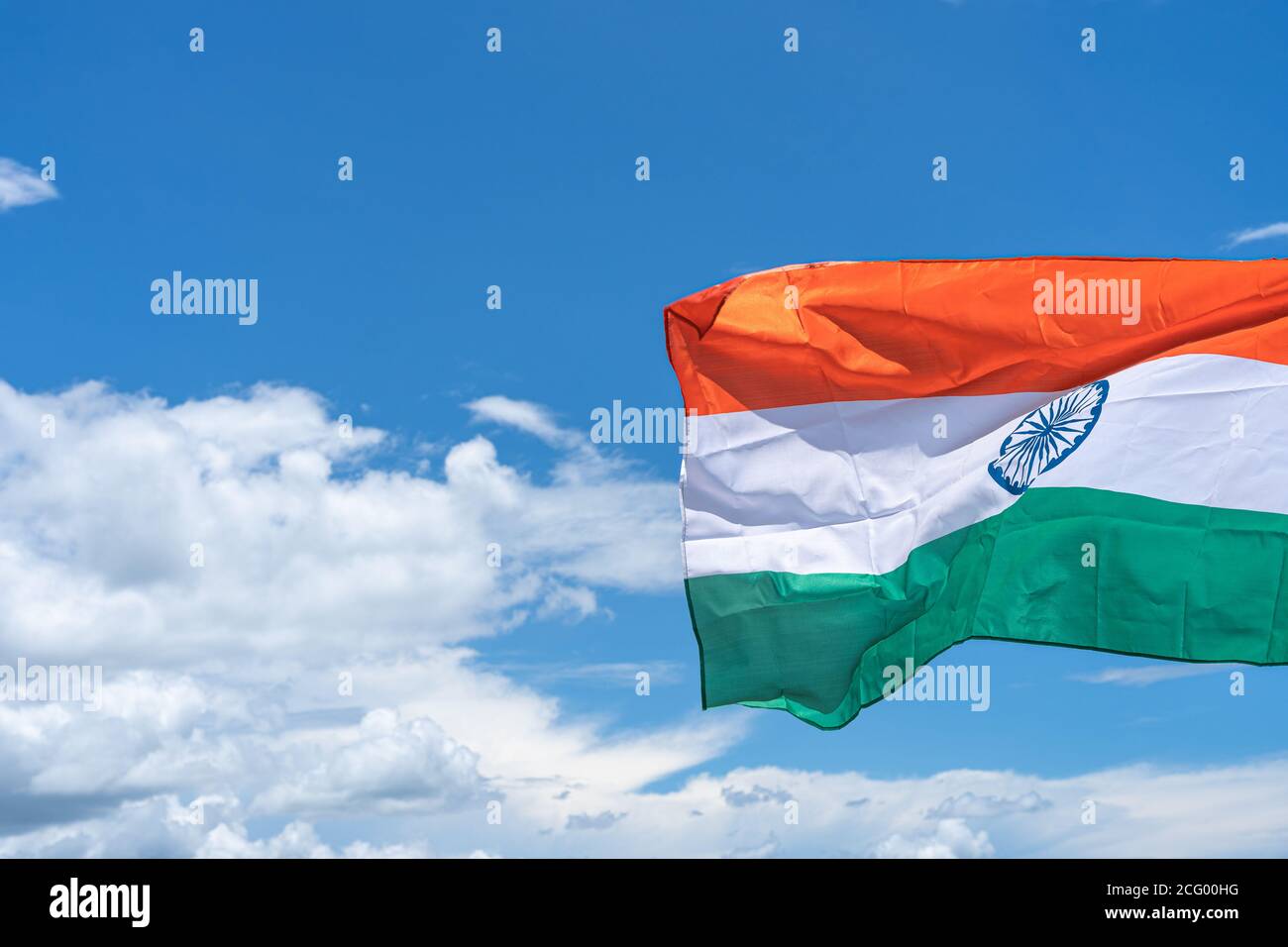 Waving India flag under blue sky background Stock Photo - Alamy