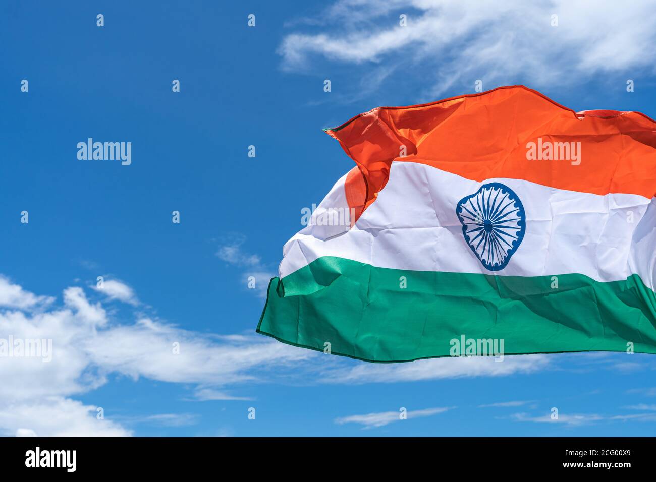 Waving India flag under blue sky background Stock Photo - Alamy