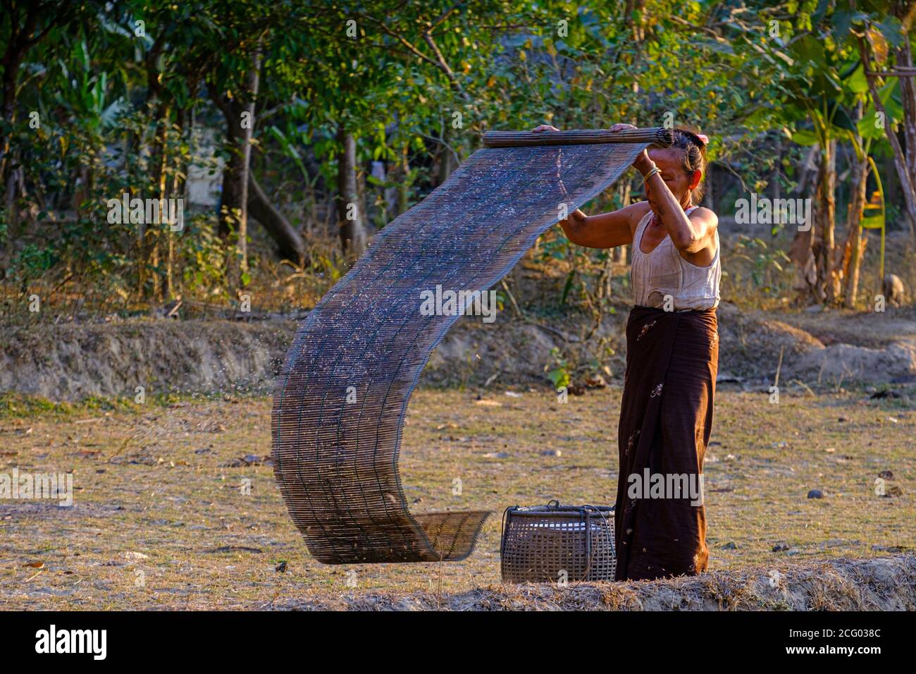 Myanmar (Burma), Karen or Kayin state, Hpa An, woman folding her mat ...