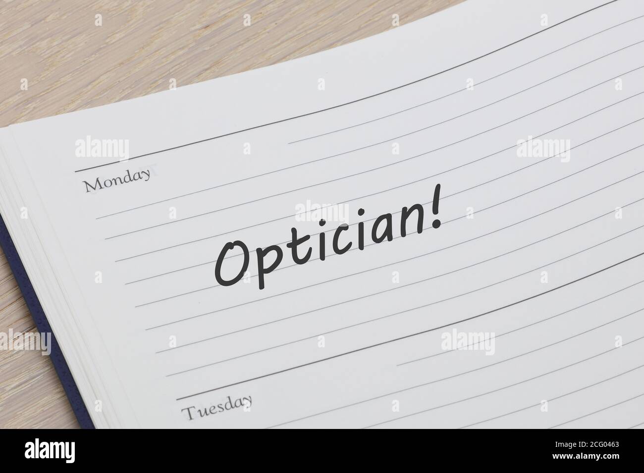 Optician appointment diary reminder open at page Stock Photo - Alamy