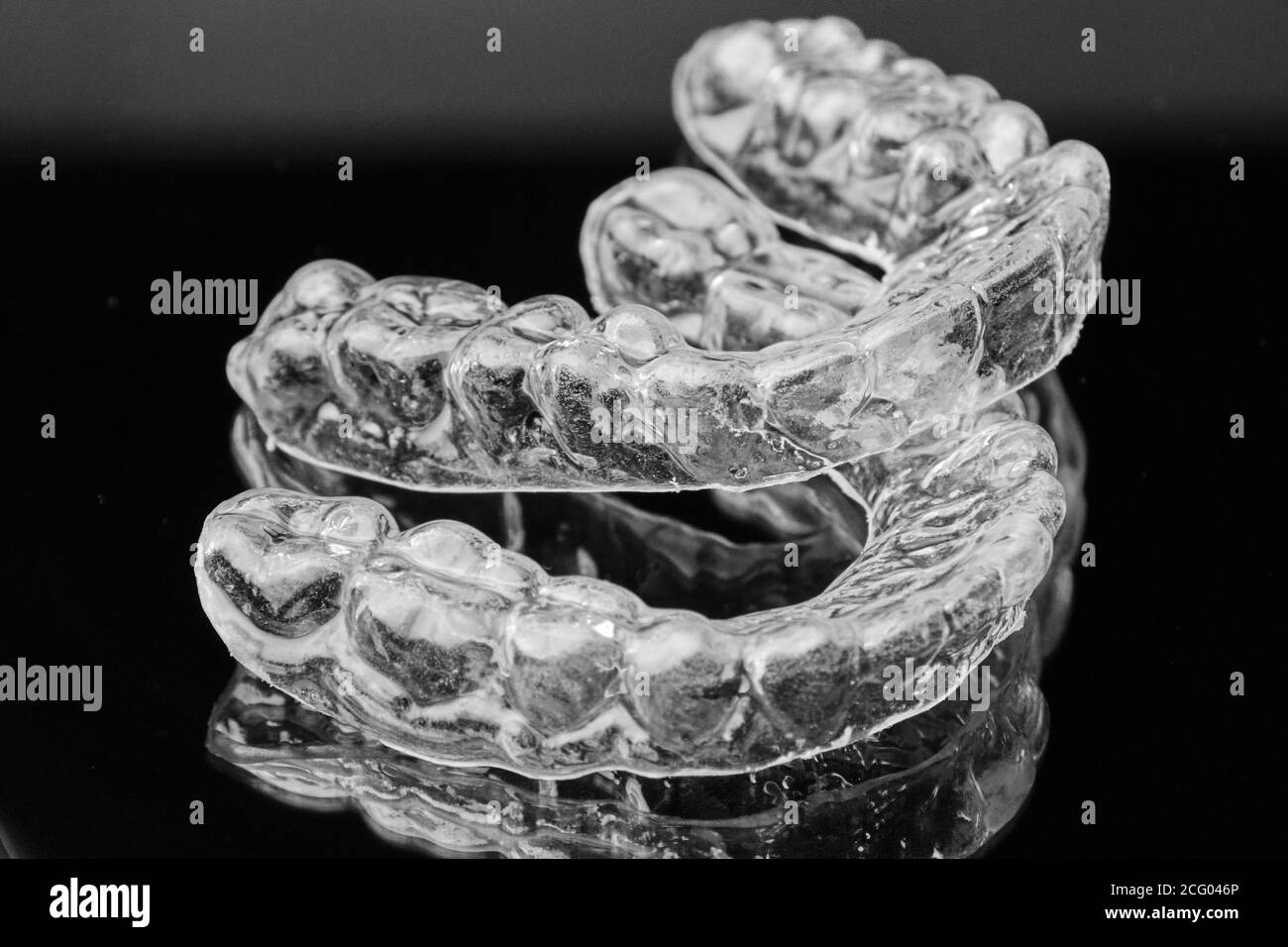 Invisible transparent dental removable braces on the black background ...