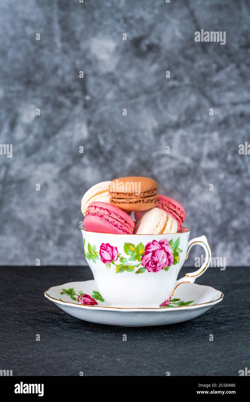 Colorful mini macarons in tea cup Stock Photo - Alamy